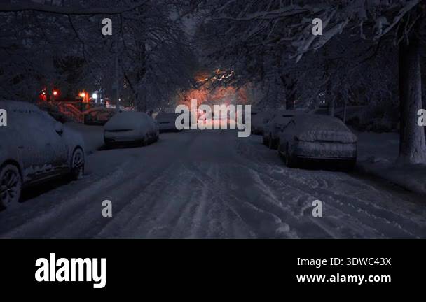 Snowy night walk in winter. Moving by the road covered with fluffy snow ...