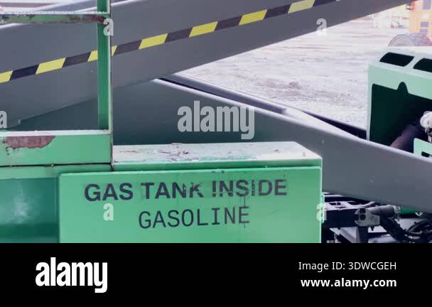 Close up of green industrial machine with warning text Gas tank inside ...
