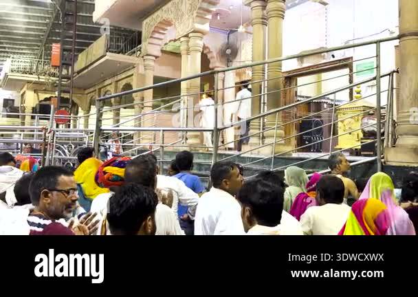devotees raising hands in prayer during hindu temple aarti ceremony ...