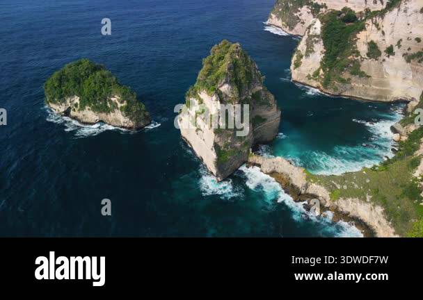 Drone aerial over Diamond Beach sea stacks and cliffs with deep blue ...