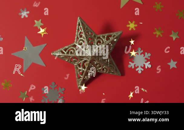 Gold sparkles drifting causing star ornament swirling letters appearing ...