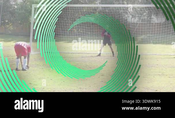 Player positioning soccer ball running then striking toward net past ...