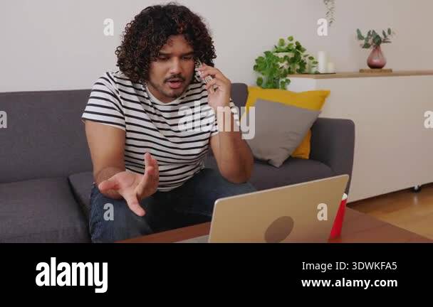 Young adult Indian man angry on phone about online banking problem at ...