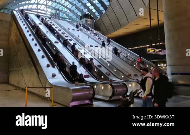 London, UK - October 31, 2025: People moving up and down an escalator ...
