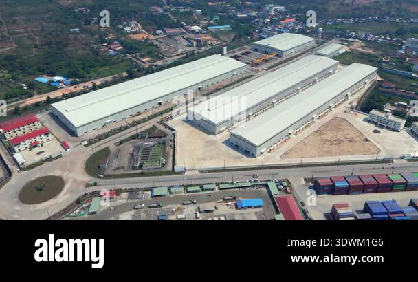 Forward aerial view of a large industrial complex featuring long ...