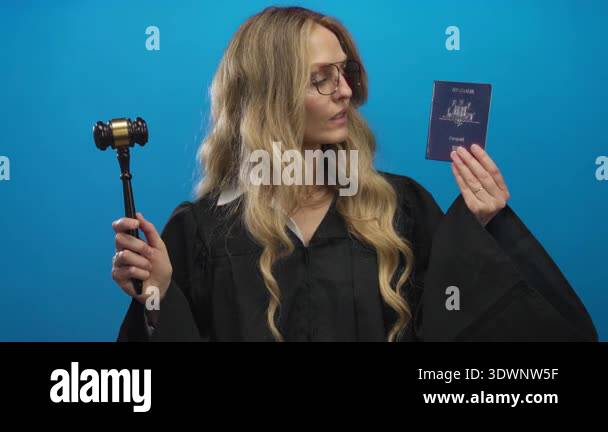 Woman judge in black robe holds an australian passport and gavel ...