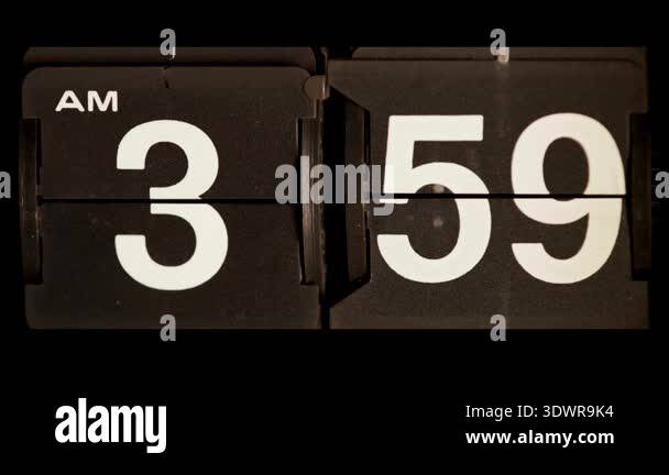 Vintage retro flip clock changing from three fifty nine am to four o ...