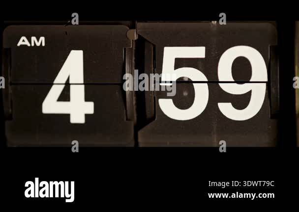 Retro vintage flip clock switching from four fifty nine am to five o ...