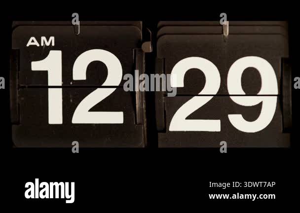 Vintage retro flip clock ticking from twelve twenty nine to twelve ...