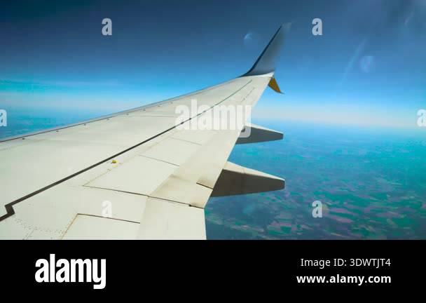 Commercial jet flying above patchy farmland. Passenger aircraft ...