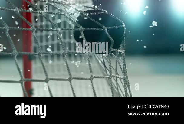 Extreme super slow motion close-up of an ice hockey puck striking the ...