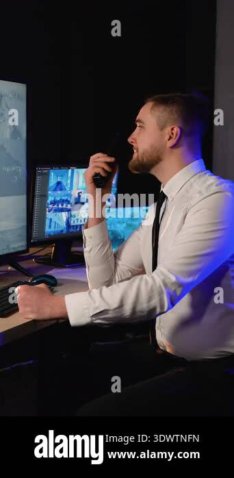 Professional security operator monitoring cctv footage on multiple ...