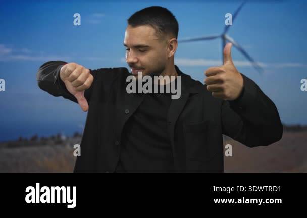 Man showing confident thumbs up and disappointed thumbs down gestures ...