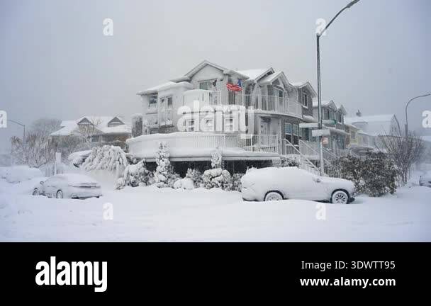 Residential house and cars covered in deep snow after blizzard ...