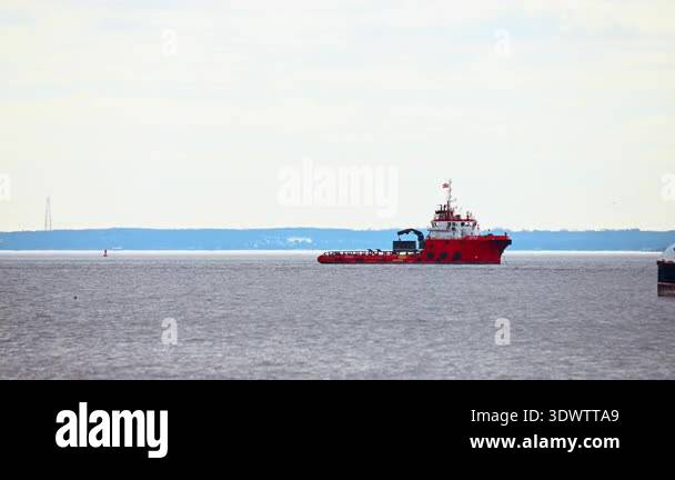 New York, USA, 22 February 2026: Red offshore supply vessel anchored in ...