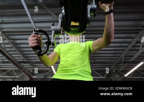 Young Man Exercising On An Upper Body Cardio Machine With Arm Rotation ...