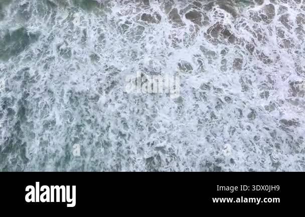 Sea movement along coastline. Ocean waves rolling steadily. Sea water ...