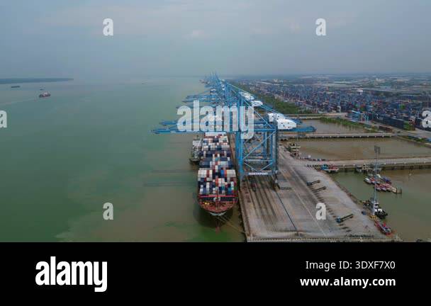 Aerial view of a large container ship docked at Northport terminal with ...