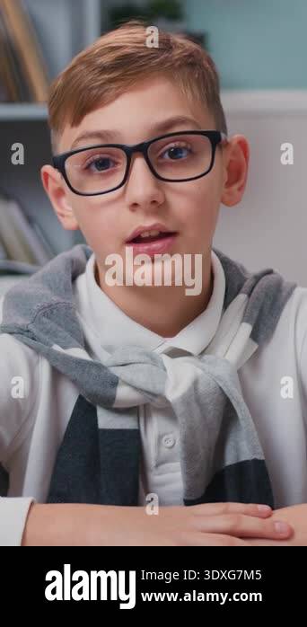 Close up portrait little boy sit on table at home look at camera having ...