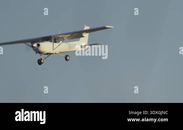 Small single-engine aircraft approaching for landing with its propeller ...