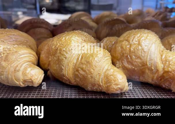 Close-up of croissants in a bakery display case, appetizing golden ...