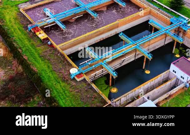 Rectangular aeration basins with blue mechanical structures and ...