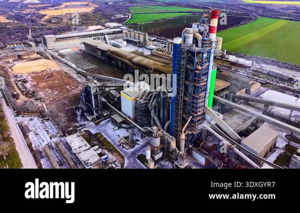 Massive industrial factory with tall towers, conveyors, and chimneys ...