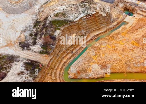 Detail of terraced earth layers in an open pit mine with a small ...