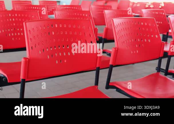 Rows of red waiting chairs with no people. Concept of queue, public ...