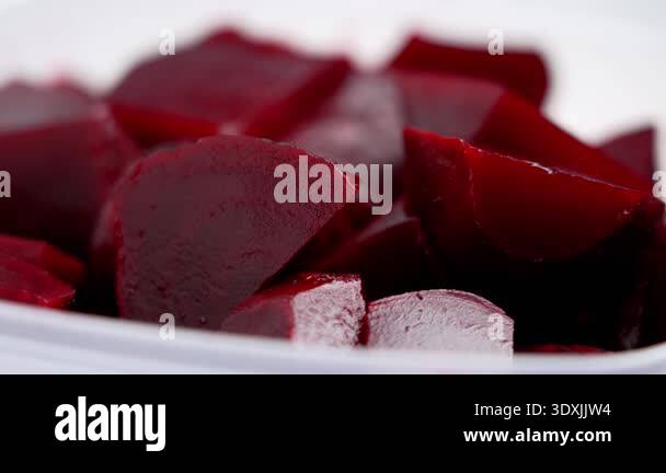 Cooked beetroot pieces in a bowl. Fresh boiled vegetable cut into ...