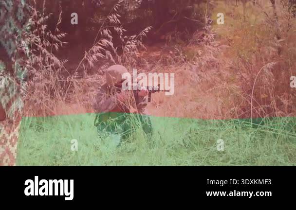 Mid adult male soldier scanning through scope then advancing through ...