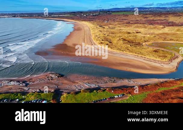 River estuary meeting the sea with sandbars and dunes. Detailed aerial ...