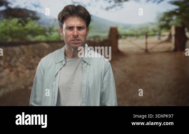 Man shouting with open mouth, face visible and teeth bared on a country ...