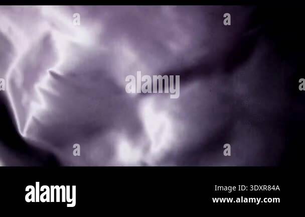 Shimmering purple satin cloth undulating in slow motion with beautiful ...