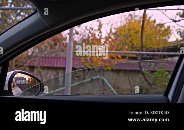 Car side window moving up and down using electric control. Closeup view ...