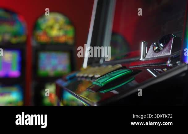 A male player plays a retro slot machine, pressing the Start and Bet ...