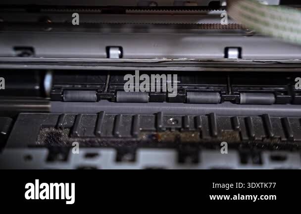 Closeup view of inkjet printer rollers spinning during device ...