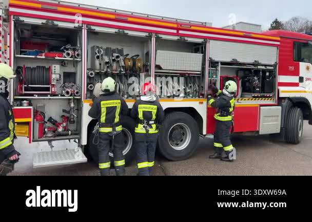 Smiltene, Latvia - March 03, 2026: Firefighters in safety gear examine ...