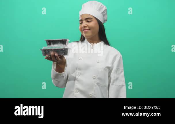 Hispanic woman chef holds stacked foil takeaway containers with open ...