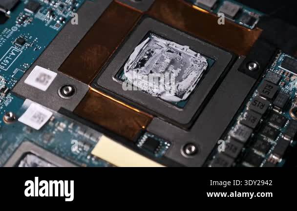 A macro rotating shot reveals a computer CPU with messy thermal paste ...