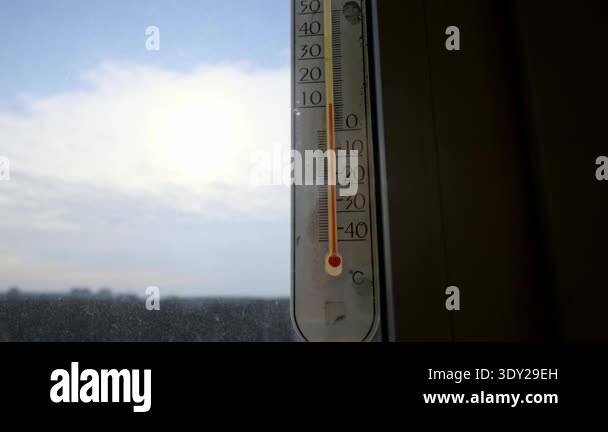 Close up of an outdoor thermometer on a window measuring low ...