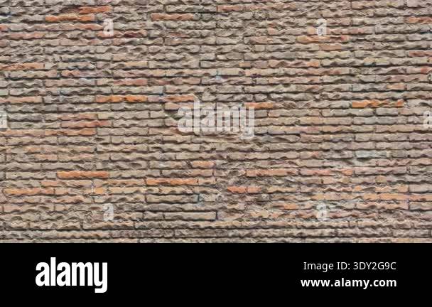 Close-up view of an old brick wall with rough surface and natural color ...