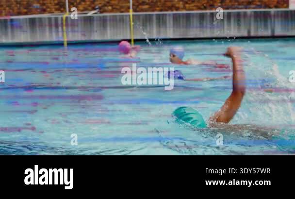 Boy in green cap kicking off wall, beginning front crawl in swim lesson ...