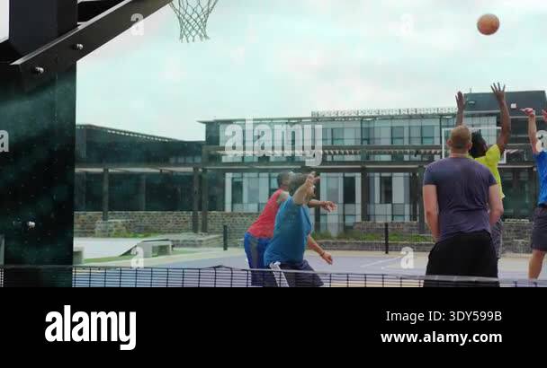 Four men vying on rooftop as ball bouncing off board, with animated arc ...