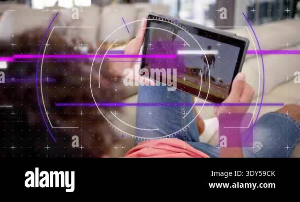 Man reclining on couch holding tablet, on-screen motion initiating HUD ...