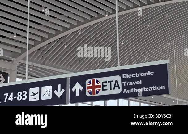 Signage in a United Kingdom airport indicating the new ETA electronic ...