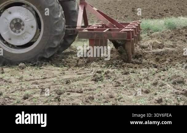 Farming Tractor Digging Deep Into the Soil - A Glimpse into Agriculture ...