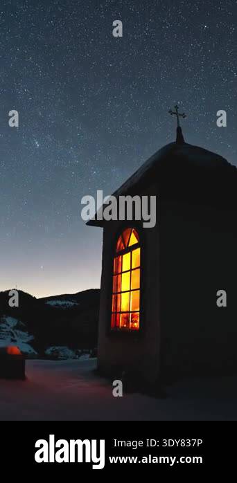 Celestial Beauty of illuminated chapel in a frozen winter countryside ...