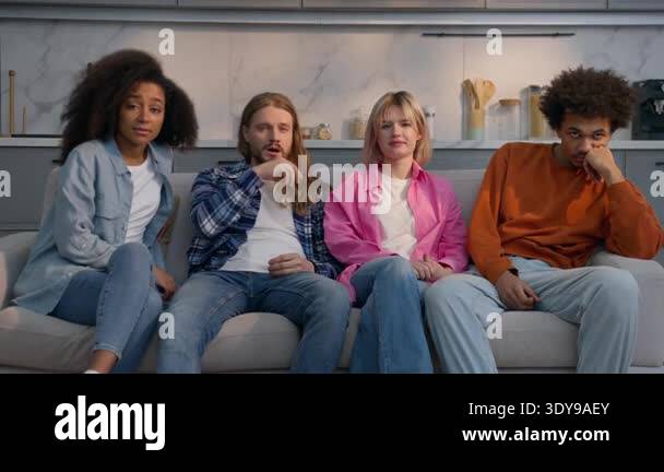 Multiethnic group of friends sitting couch at home bored watching TV ...