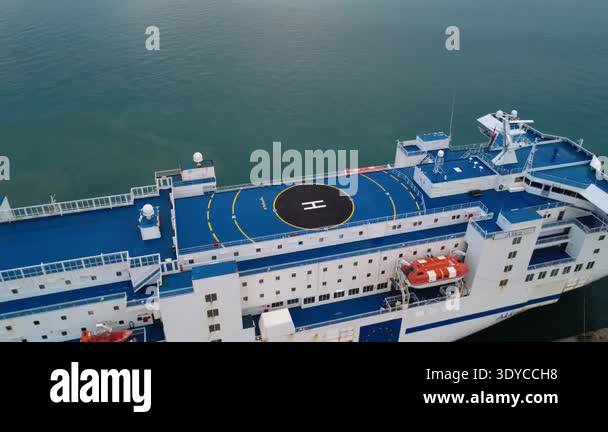 Large vehicle ferry moored at a commercial port with clear view of ...